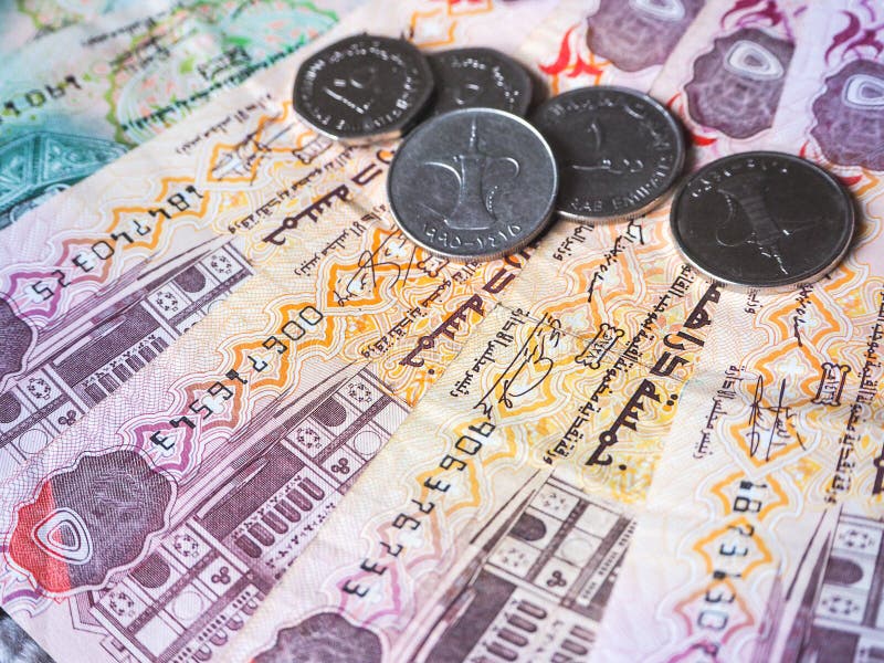 Arabic Coins of Dirhams. Curled Banknotes in His Hands. Stock Photo ...