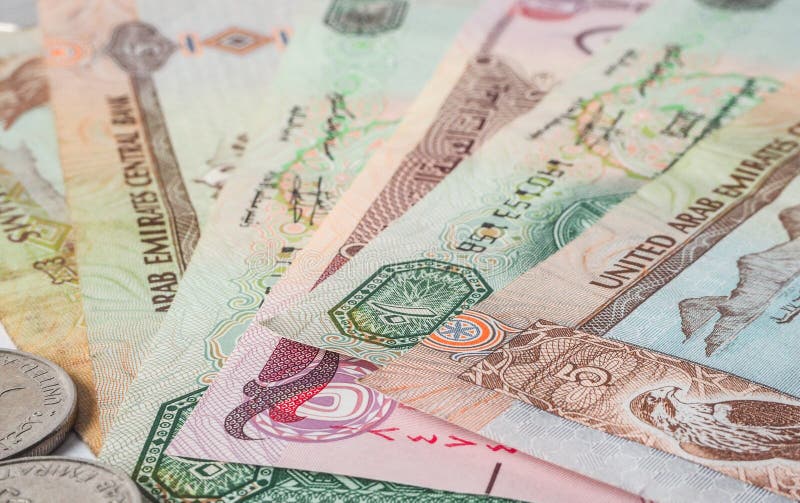 Arabic Coins of Dirhams. Curled Banknotes in His Hands. Stock Image ...