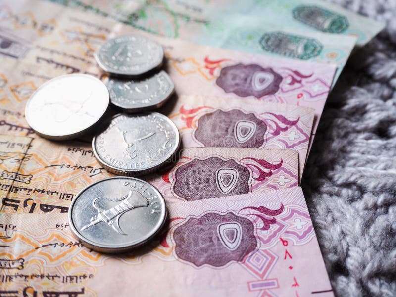 Arabic Coins of Dirhams. Curled Banknotes in His Hands. Stock Image ...