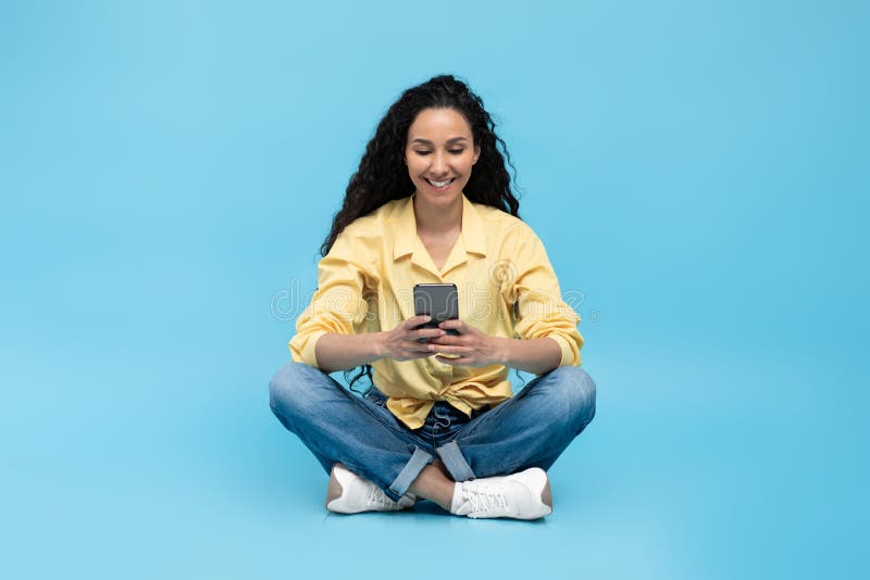 Arabic Female Using Mobile Phone Texting Sitting Over Blue Background ...