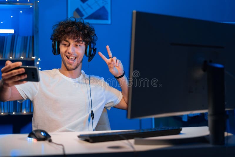 Arabic Guy Gamer in a Headset Playing Computer Games Sits at a Computer ...