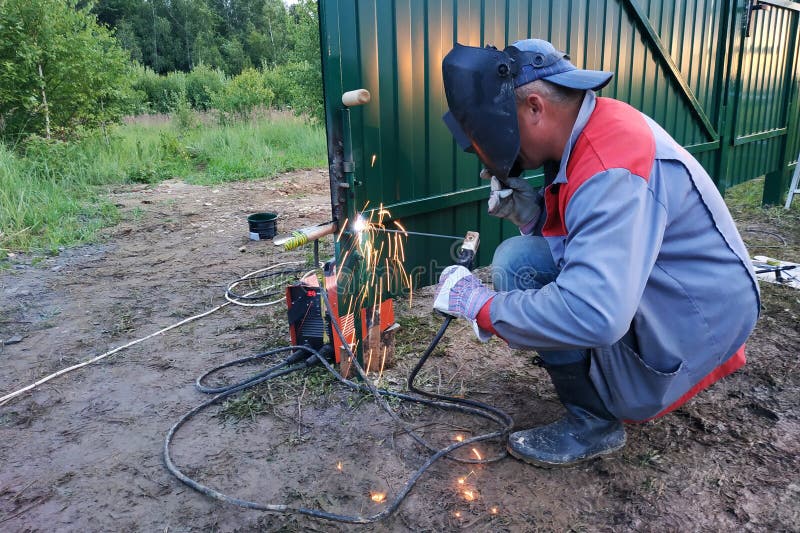 Arc Welding is a Power Tool, Welding a Metal Fence, Construction Work ...