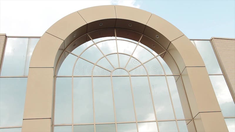 Arch Arc Windows on Beige Mall Storefront with Reflection of Clouds ...
