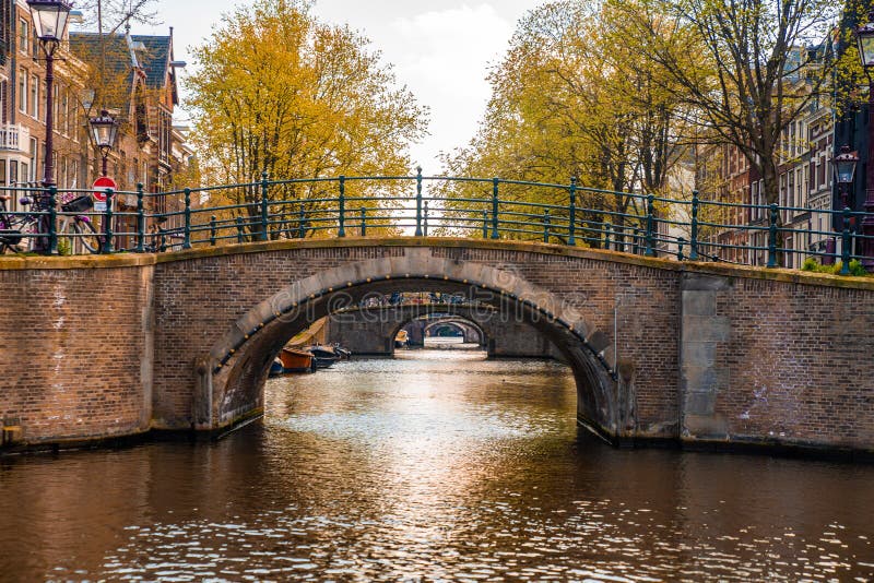 Arch Bridge Over a River in Amsterdam, the Netherlands Stock Image ...