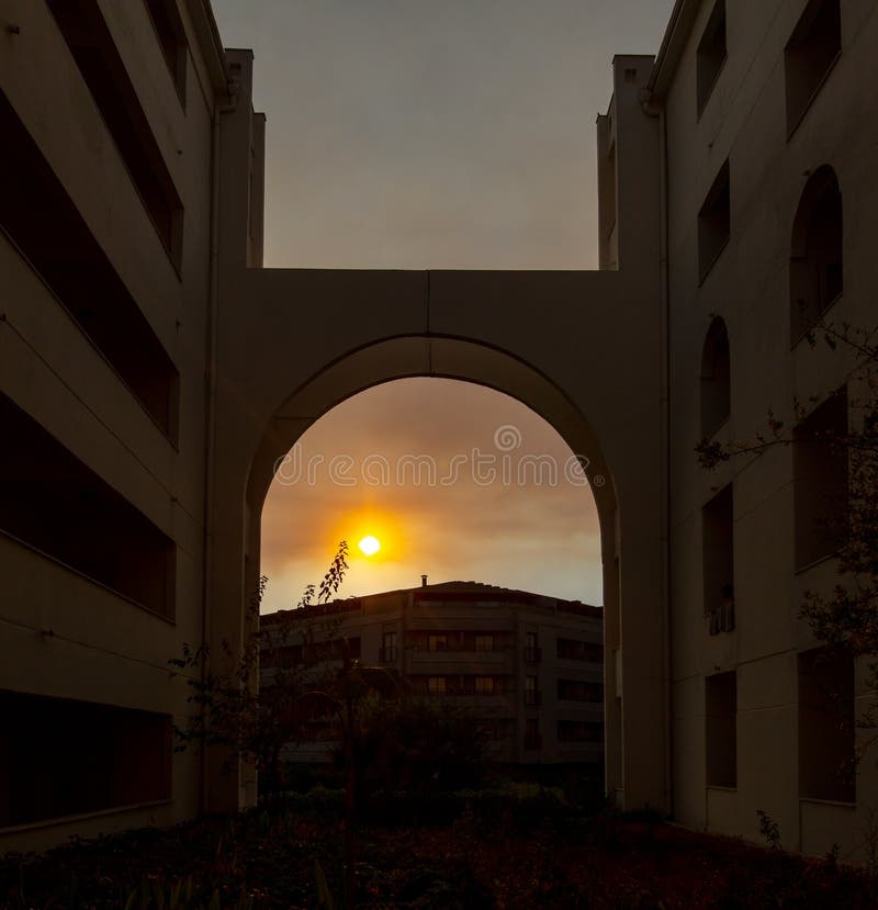 Arch between Buildings on the Background of Sunset. Stock Image - Image ...