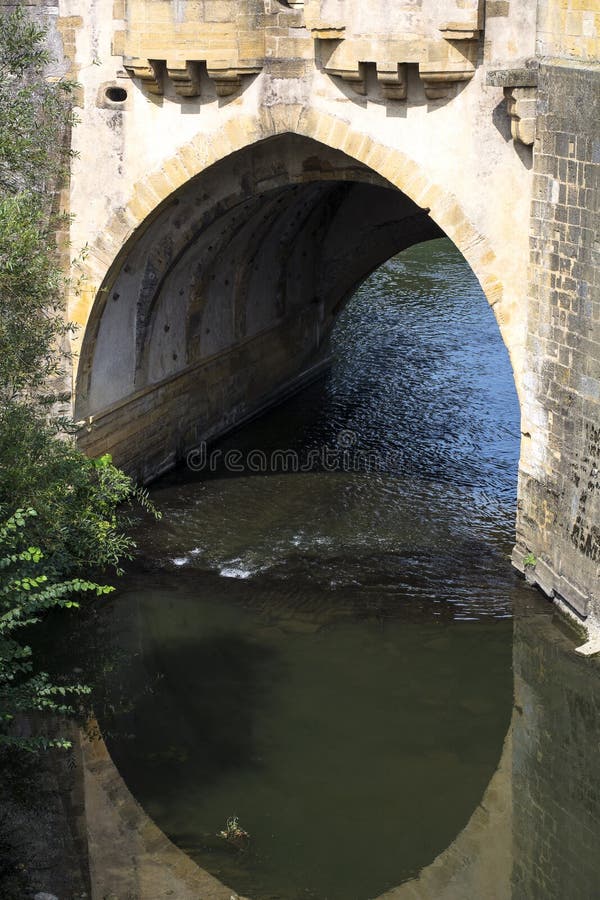 An Arch of an Old French Bridge Over the River Stock Image - Image of ...