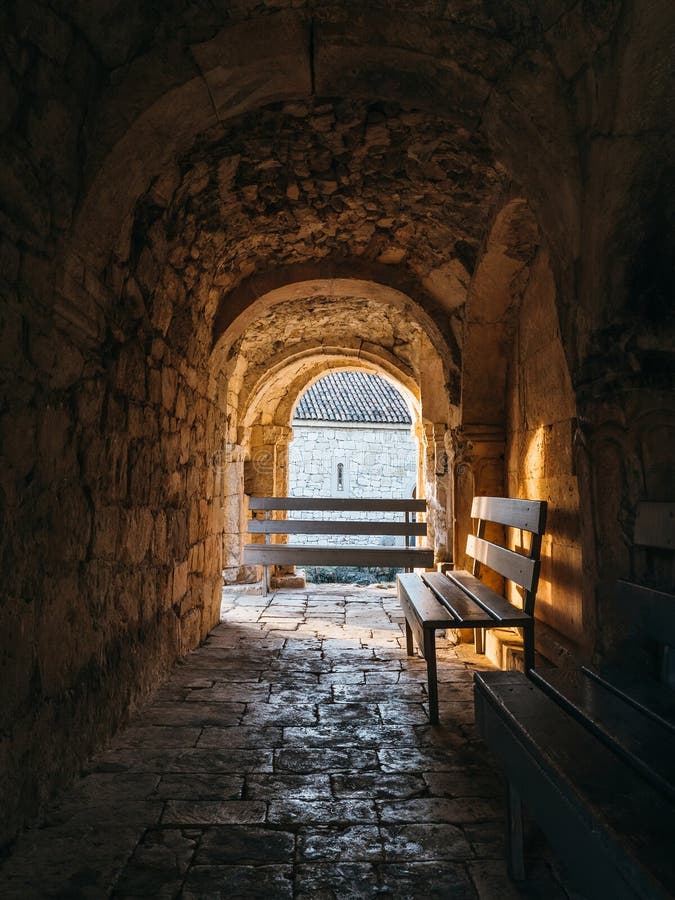 Arch-shaped Corridor with Bench Inside Ancient Stone Monastery of 13th ...