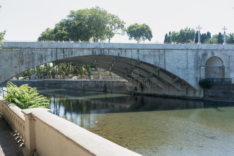 Arch of a Stone Bridge Over the Water of a Water Canal in the City ...