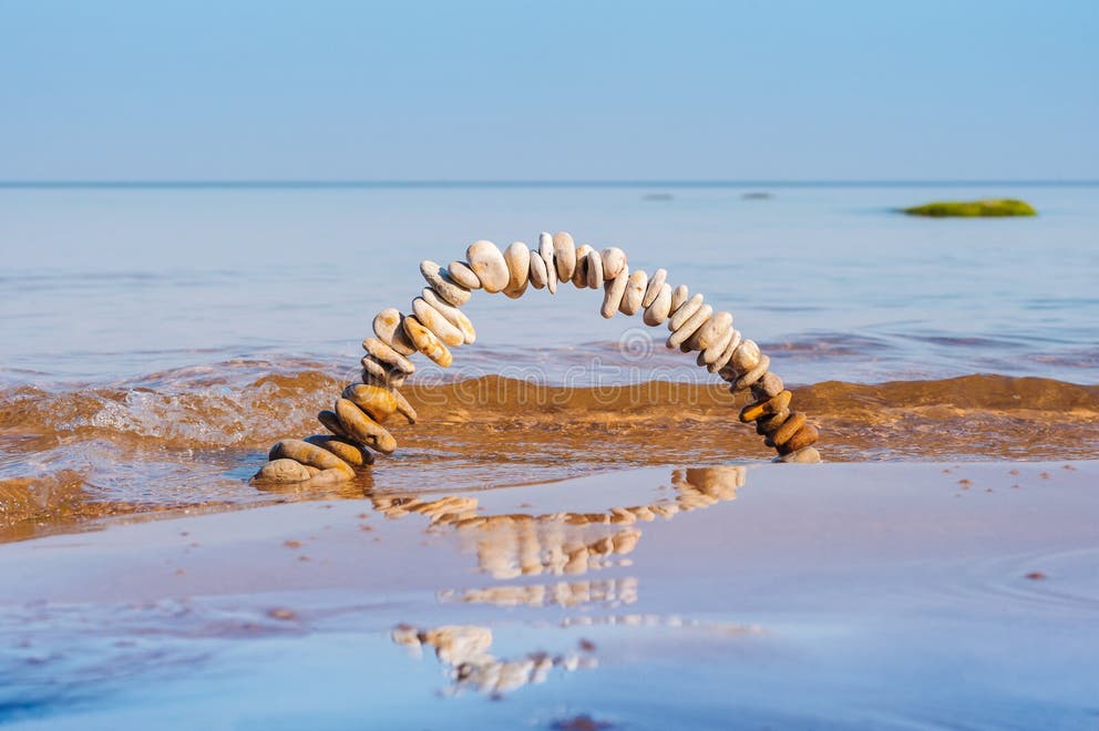 Arch on the wet sand stock photo. Image of arch, poise - 69699804
