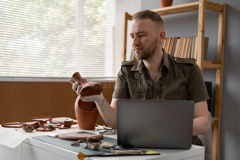 Archaeological Digging. Male Archaeologist Doing Research, Using Laptop ...