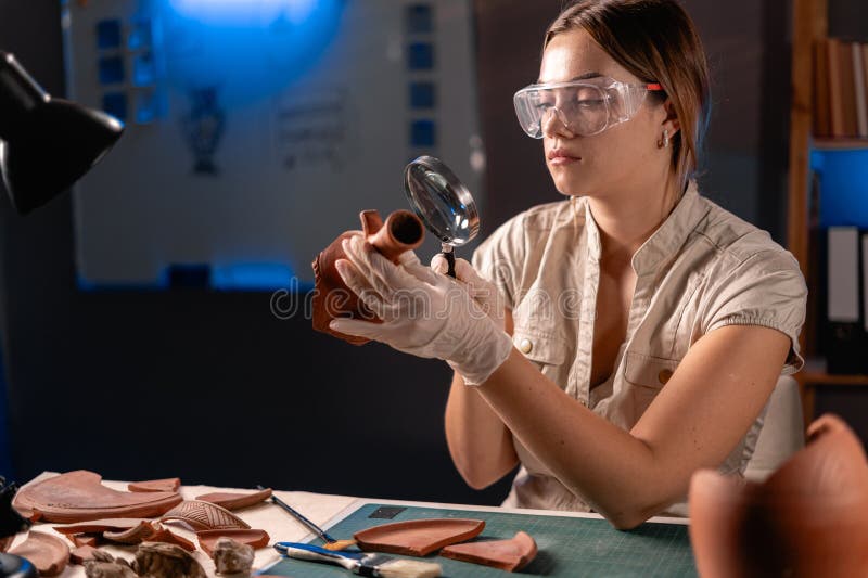 Archaeologist Studying an Ancient Artifact Using a Magnifying Glass and ...