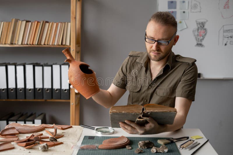 Archaeologist Working in an Office Studying Ancient Artifacts of ...