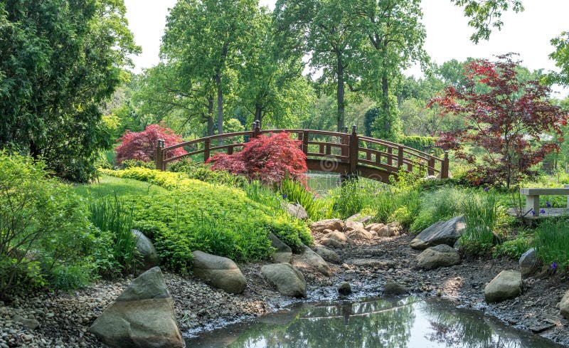 Arched Bridge in a Pretty Spring Garden Stock Photo - Image of foliage ...