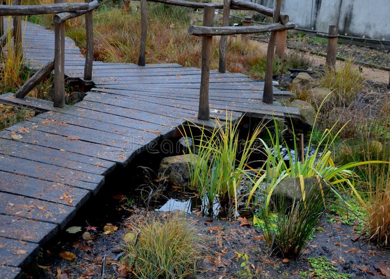 Arched Wooden Bridge in the Park. the Railing Posts are Connected Stock ...