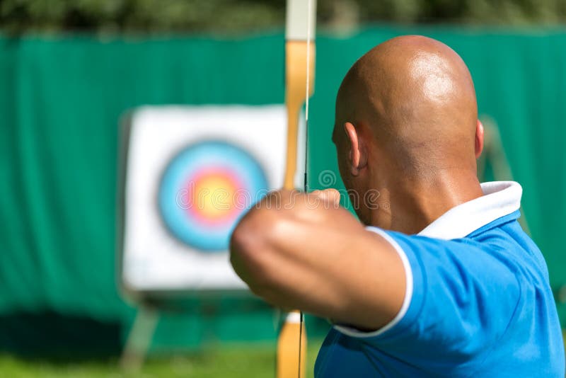 Archer Aiming at Target with Bow and Arrow Stock Photo - Image of focus ...
