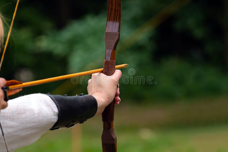 Archer Holds His Bow Aiming at the Target. Archery Competition, Outdoor ...