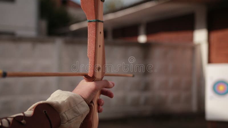 Guy Shoots from String, Wooden Arrows with Color End of Fly Target ...