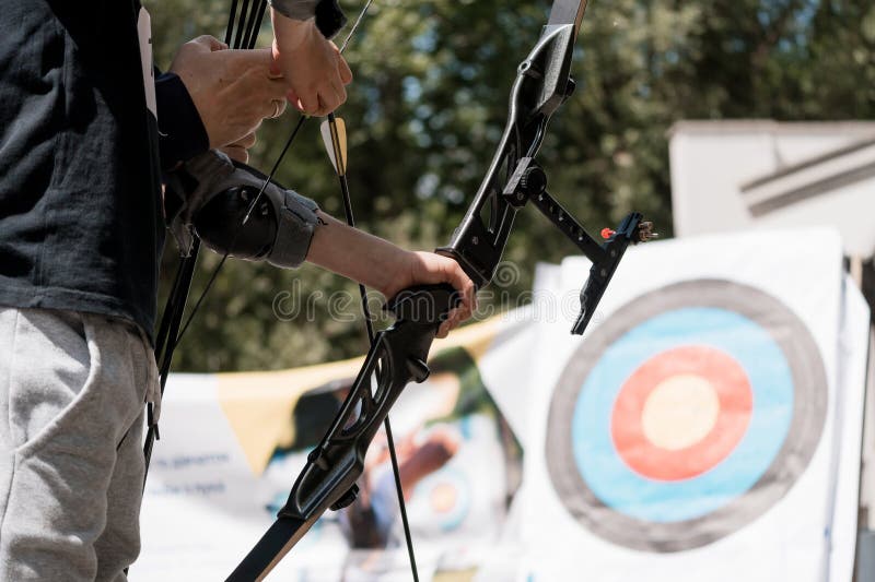 Archery Practice Outdoors: Young Athlete Pulls Back Bowstring, Aiming ...