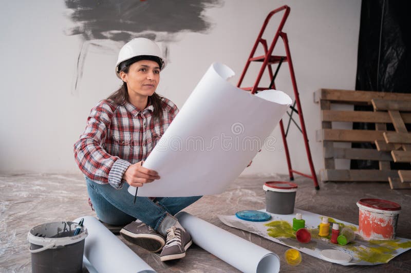 Architect Builder Studying Layout Plan of the Rooms while Sitting on ...