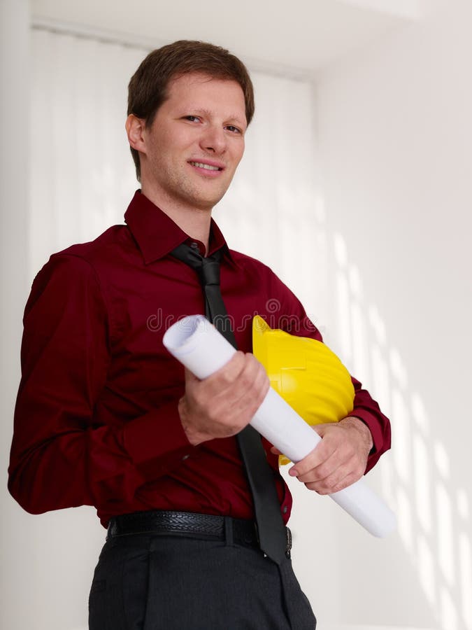 Architect with Building Plans Smiling at Camera Stock Image - Image of ...
