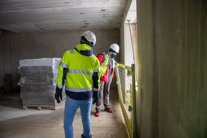 The Architect of the Building Project and the Construction Manager Walk ...