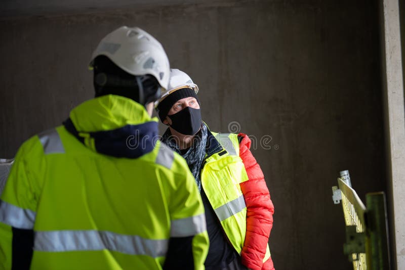 The Architect of the Building Project and the Construction Manager Walk ...