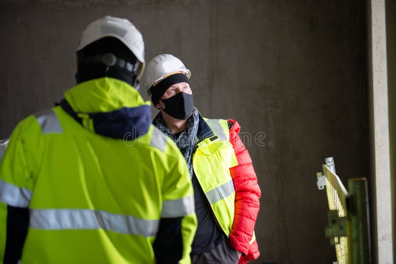 The Architect of the Building Project and the Construction Manager Walk ...