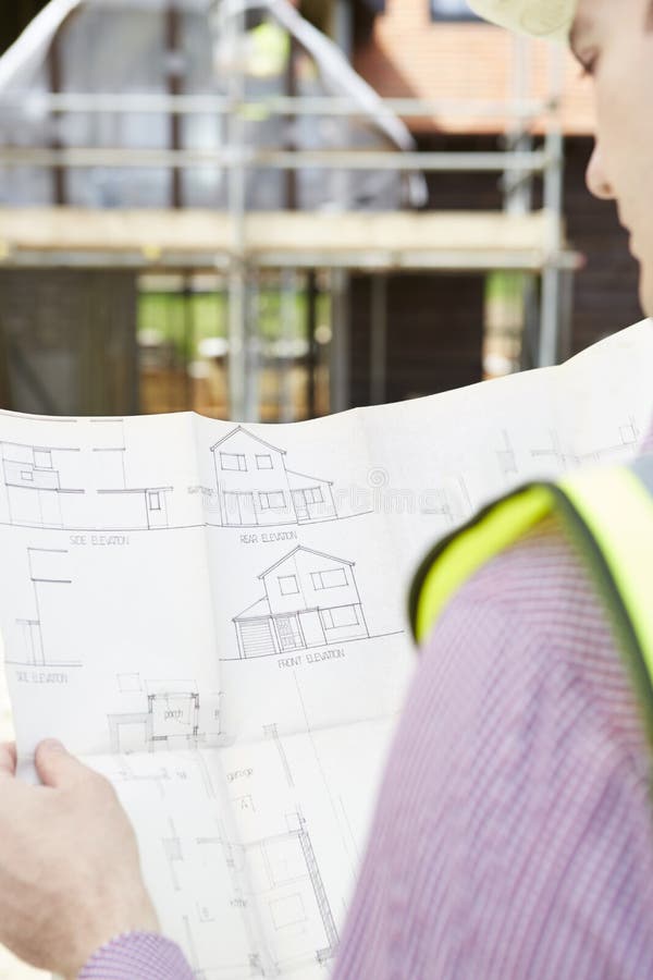 Architect on Building Site Looking at House Plans Stock Photo - Image ...