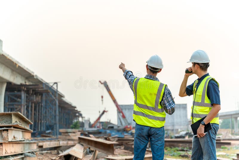 Architect and Civil Engineer Checking Work with Walkie-talkie for ...