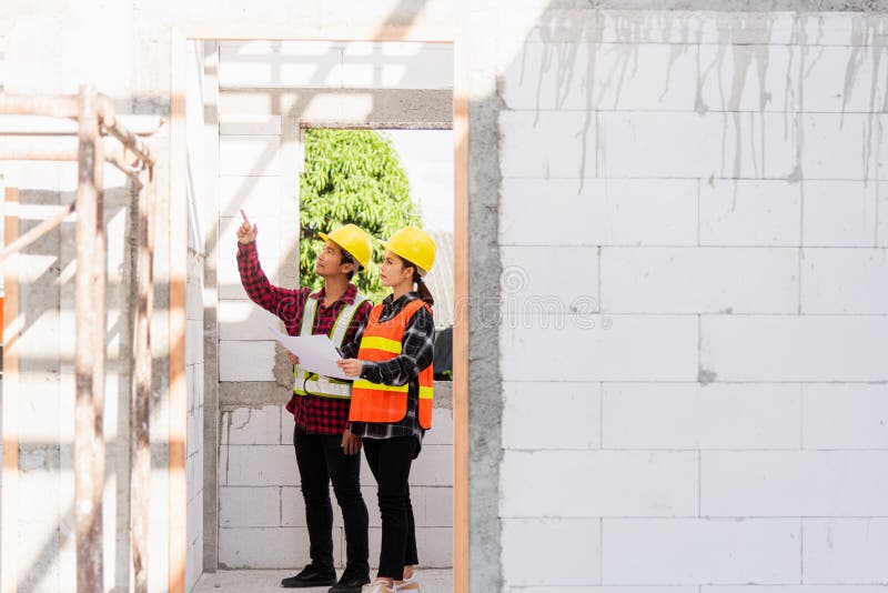 Architect and Client Discussing the Plan with Blueprint of the Building ...