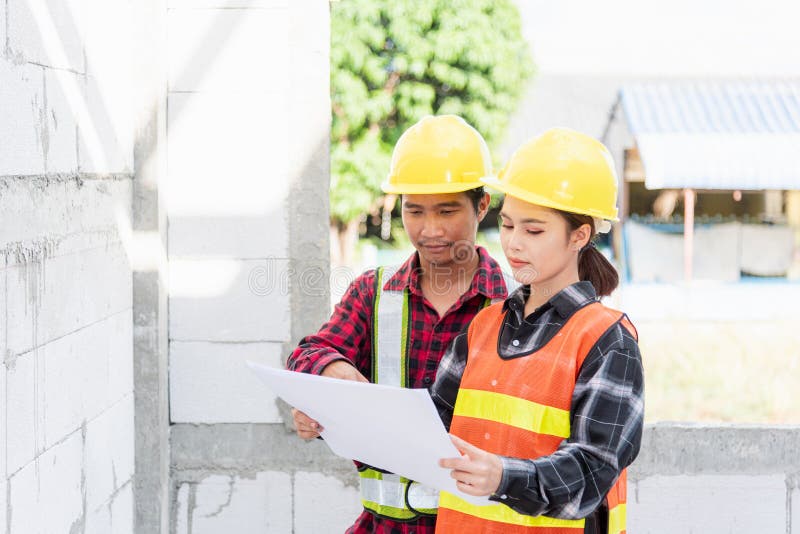 Architect and Client Discussing the Plan with Blueprint of the Building ...