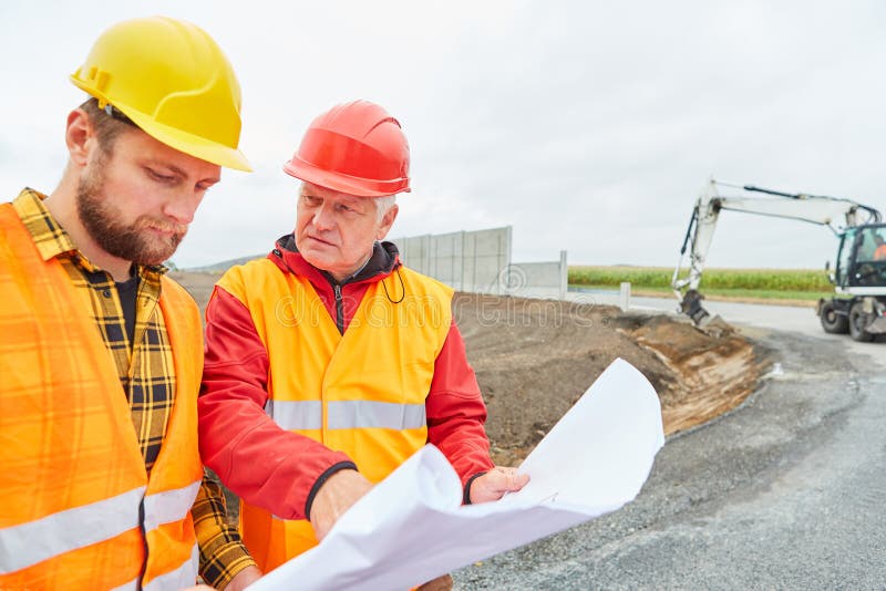 Architect and Construction Manager with Construction Drawing on ...