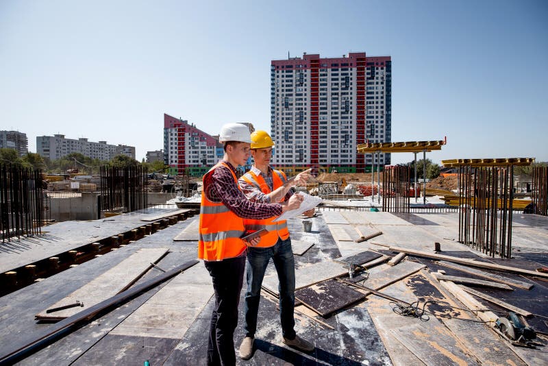 Architect and Construction Manager Dressed in Orange Work Vests and ...