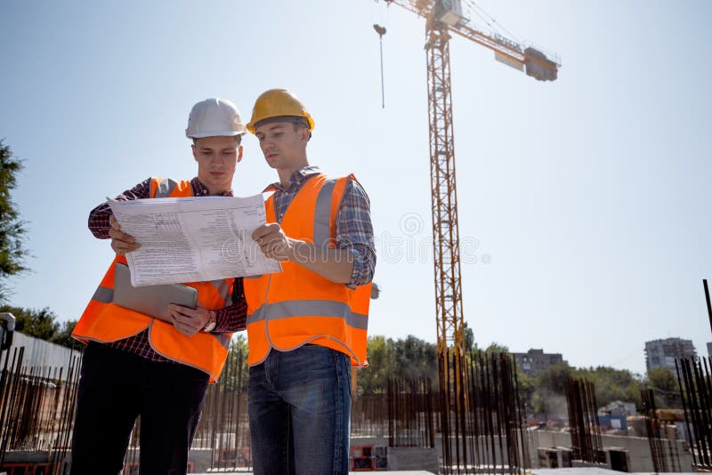 Architect and Construction Manager Dressed in Orange Work Vests and ...