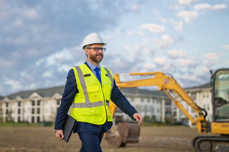 Architect at a Construction Site. Architect Man in Suit and Helmet at ...