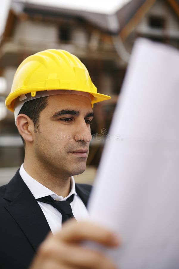 Architect in Construction Site Looking at Building Plans Stock Photo ...