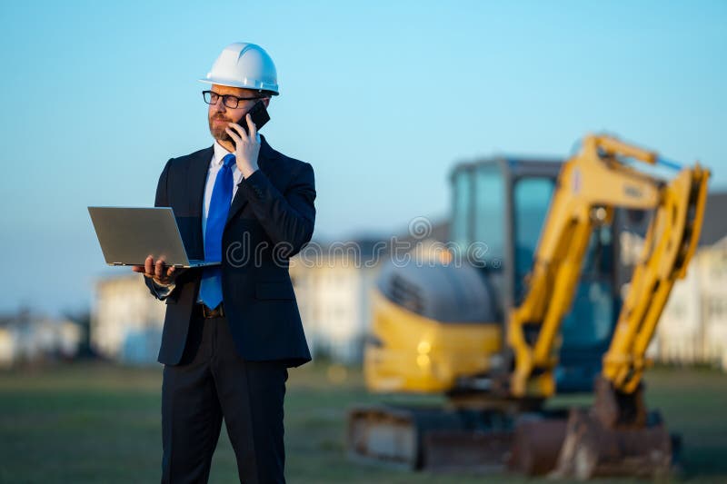 Architect at a Construction Site. Architect Man in Suit and Helmet at ... Architect at a Construction Site. Architect Man in Suit and Helmet at ...
