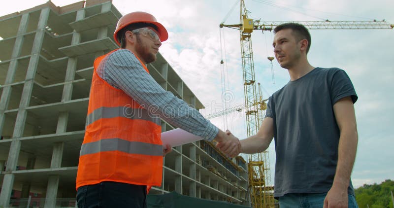 Architect Contractor Shaking Hands with Client at Construction Site ...