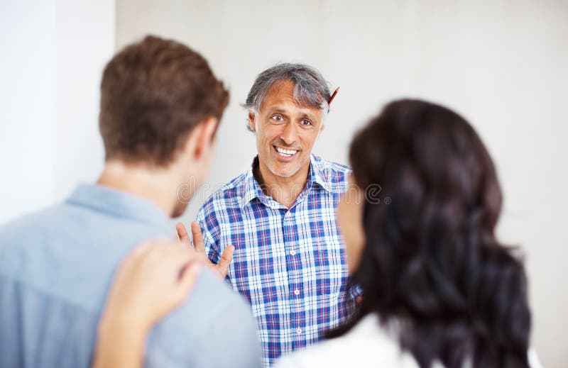 Architect in Conversation with Couple. Focus on Mature Architect in ...