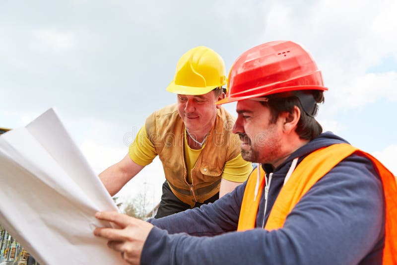 Architect and Craftsman Look at a Blueprint Stock Image - Image of ...