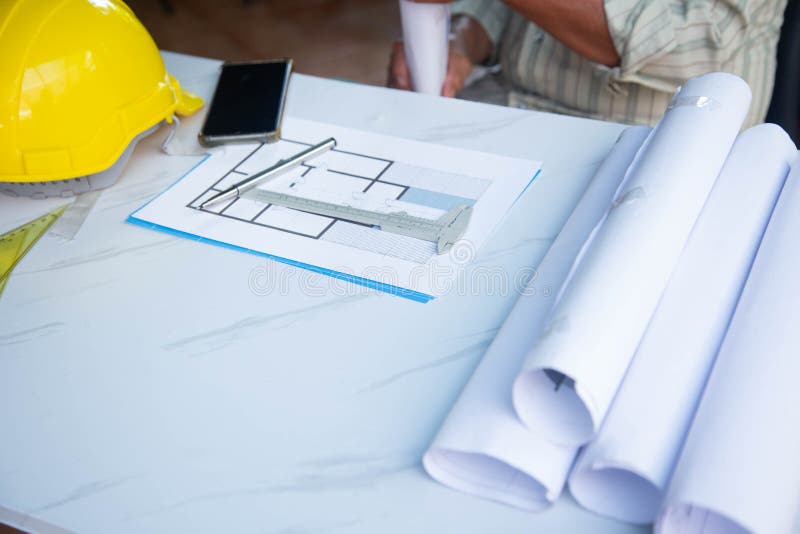 Architect Designing Project at Construction Site with Blueprint Stock ...