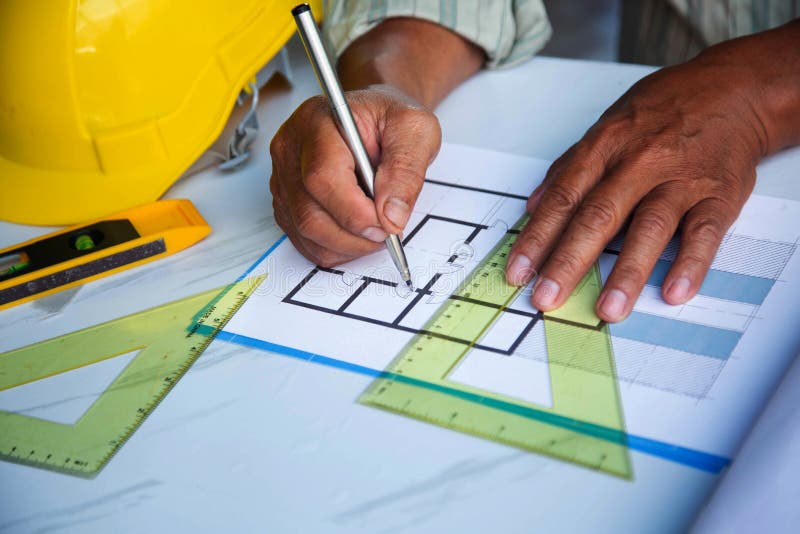 Architect Designing Project at Construction Site with Blueprint Stock ...