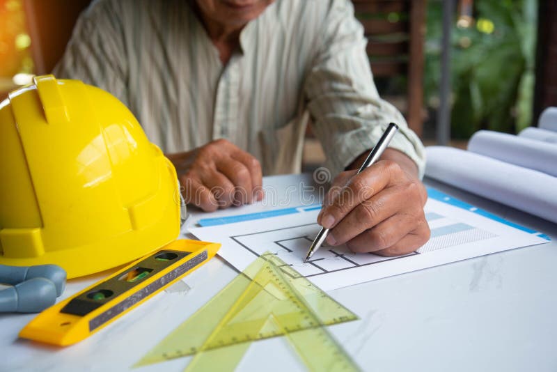 Architect Designing Project at Construction Site with Blueprint Stock ...