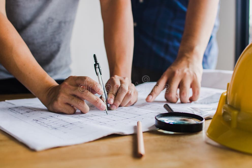 The Architect is Designing Using a Blueprint for Construction in the ...