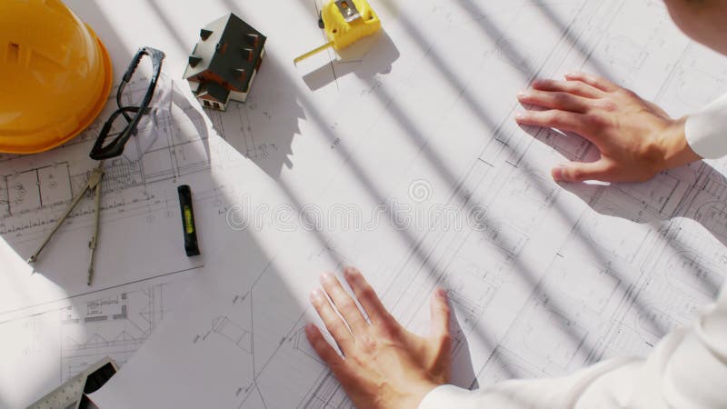 Architect Drawing Blueprints, Architectural Project in Progress ...