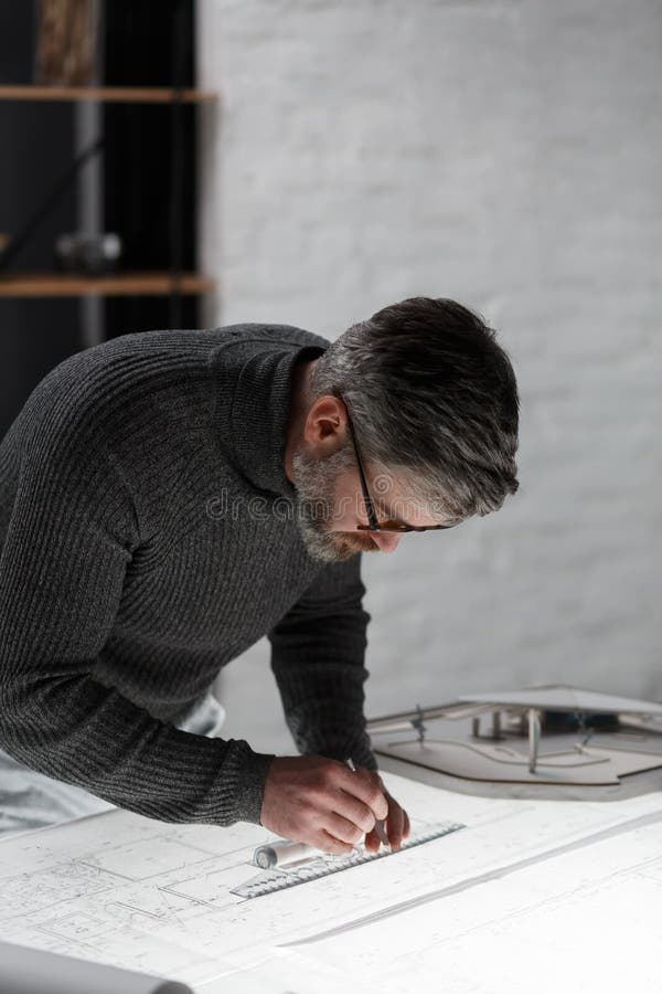 Architect Drawing Blueprints in Office. Engineer Sketching a ...