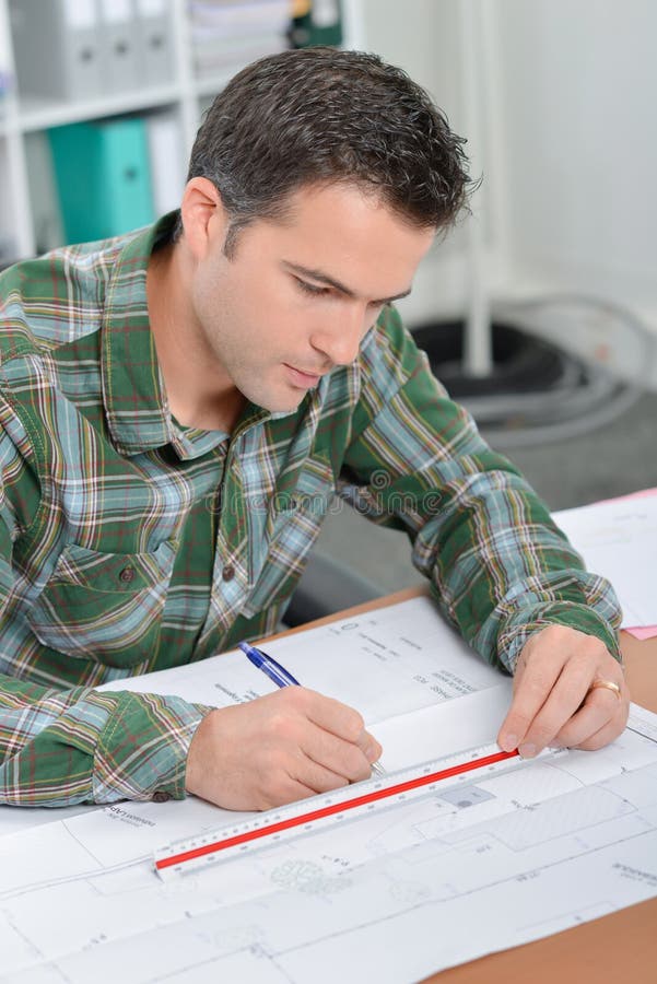 Architect drawing at desk stock image. Image of blueprint - 83781325