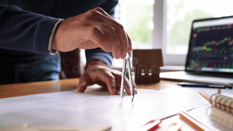 Architect Draws Elements of House Interior with Compass on a Blueprint ...