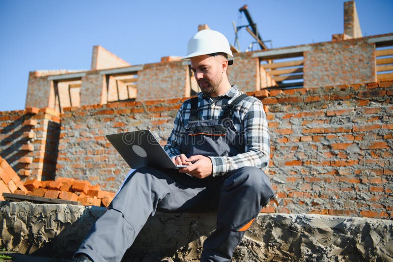 Architect or Engineer on Construction Site with Laptop Monitoring ...