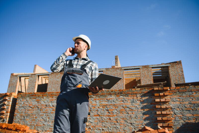 Architect or Engineer on Construction Site with Laptop Monitoring ...
